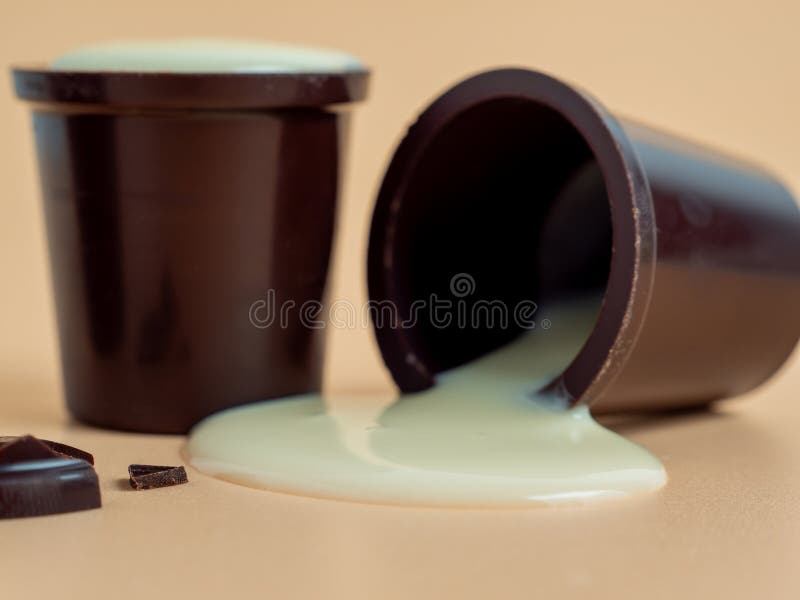 Chocolate Cup Filled with White Pudding on an Orange Background ...