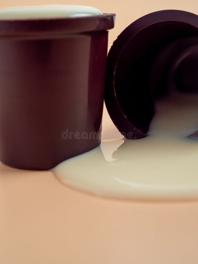 Chocolate Cup Filled with White Pudding on an Orange Background ...