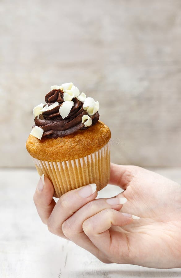 Chocolate cupcake in hand stock photo. Image of fancy - 38264076