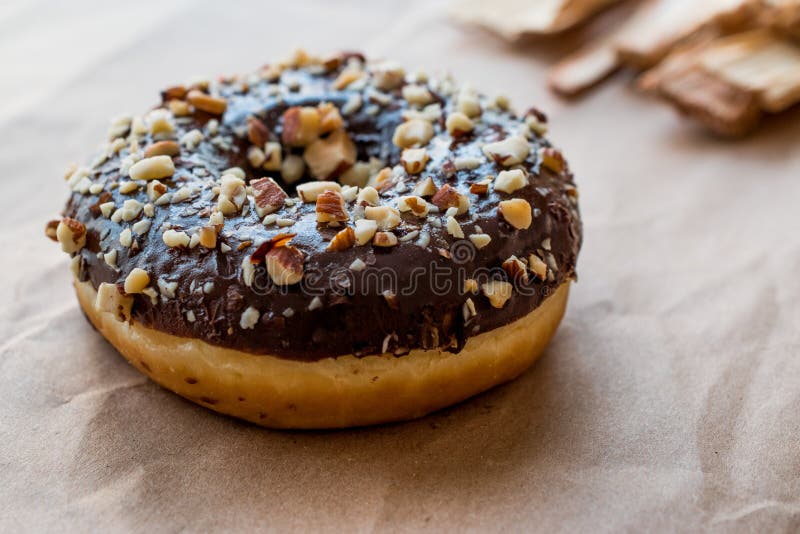 Chocolate Donut with Diced Hazelnut Pieces. Stock Image - Image of ...