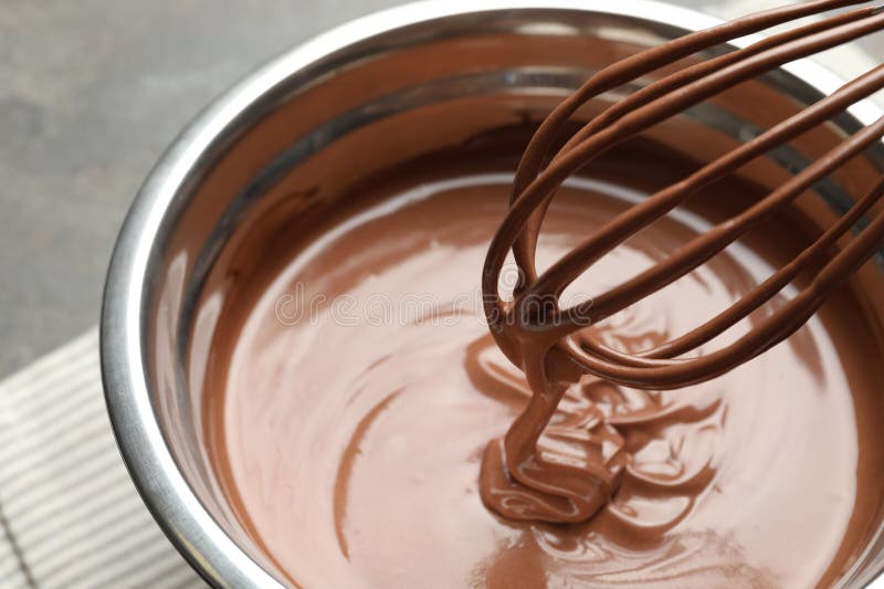 Chocolate Dough Dripping from Whisk into Bowl on Table, Closeup Stock ...