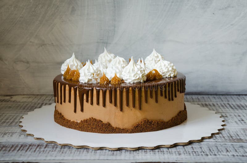 Chocolate Drip Cake with Salted Caramel and Snow White Merengues Stock ...