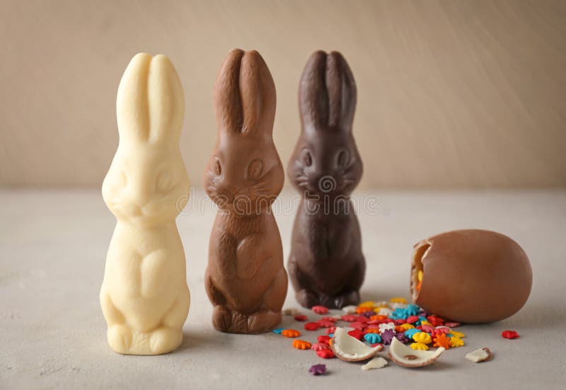 Chocolate Easter Bunnies and Egg on Table Stock Photo - Image of ...
