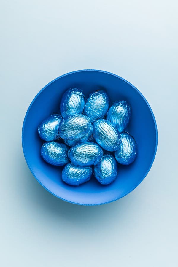 Chocolate Easter Eggs Wrapped in Blue Colored Foil on Blue Background ...