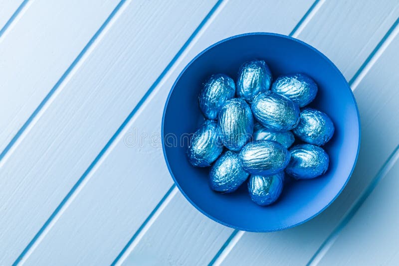 Chocolate Easter Eggs Wrapped in Blue Colored Foil on Blue Table Stock ...