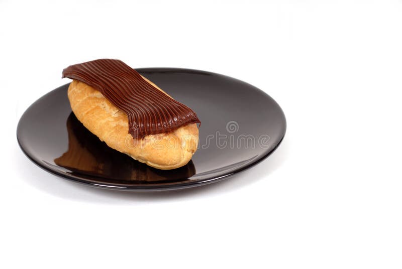Chocolate Eclair on Black Plate Stock Image - Image of calories ...