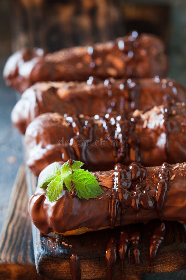 Chocolate Eclair Decorated with Mint and Melted Chocolate Stock Photo ...