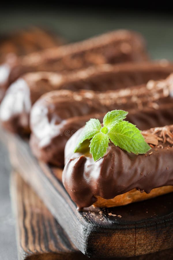 Chocolate Eclair Decorated with Mint and Melted Chocolate Stock Photo ...