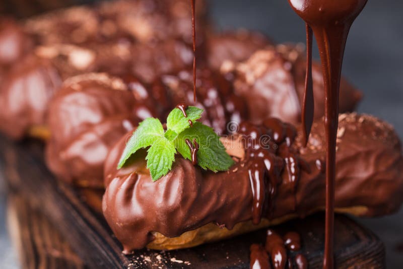 Chocolate Eclair Decorated with Mint and Melted Chocolate Stock Photo ...