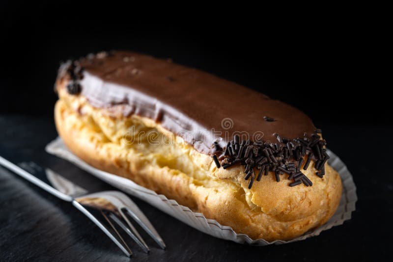 Chocolate Eclair on a Paper Plate with Fork Stock Image - Image of ...