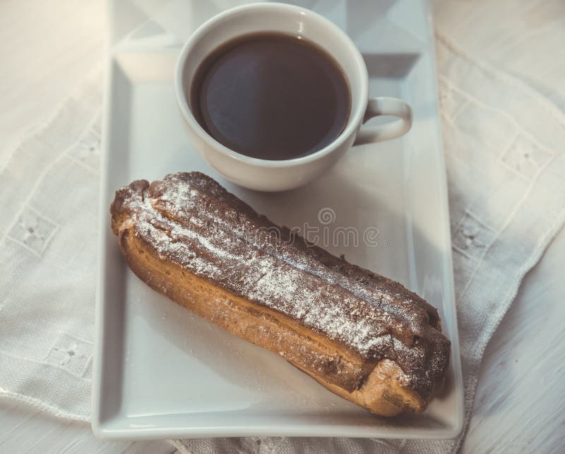 Chocolate Eclair and Coffee Stock Photo - Image of coffee, pastry: 85748900