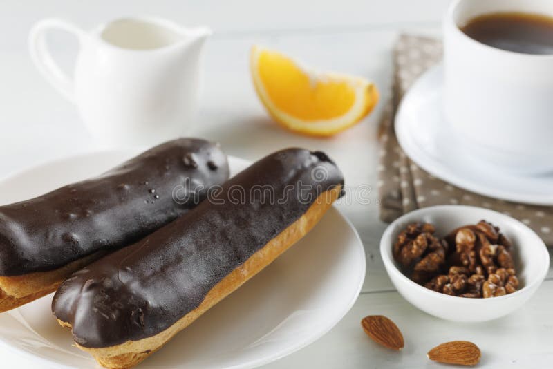 Chocolate Eclairs with Coffee and Milk. Traditional Sweet Breakfast ...