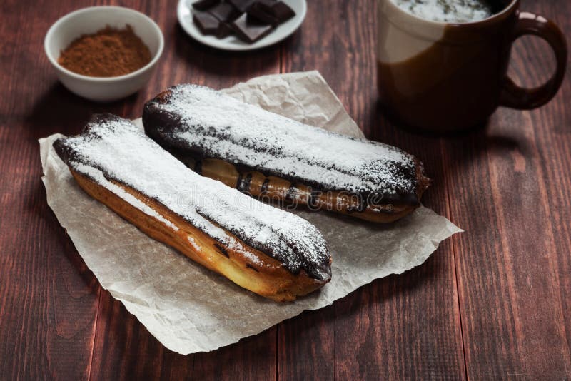 Chocolate Eclairs on Parchment Paper Stock Photo - Image of puff ...