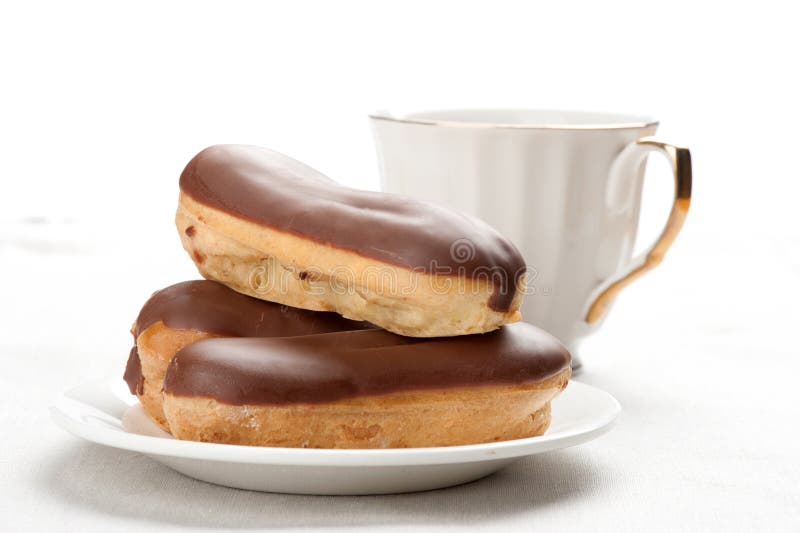 Cup of tea and eclairs stock photo. Image of sweets, frosting - 39913950