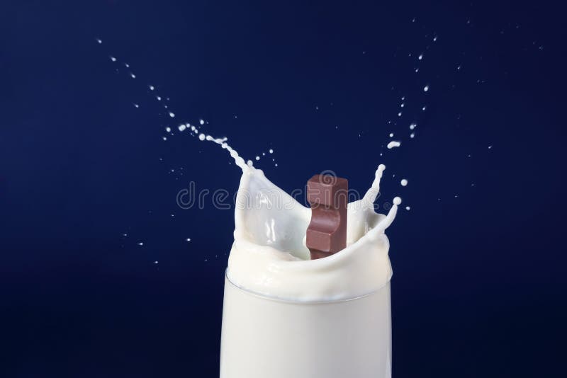 Chocolate Falling into Milk on Blue Background Stock Photo - Image of ...