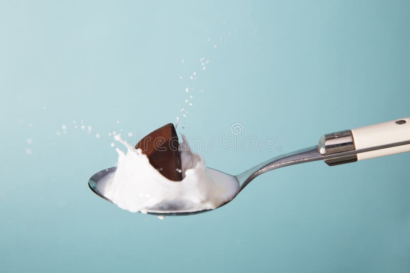 Chocolate Falling on a Spoon of Milk Stock Image - Image of delicious ...