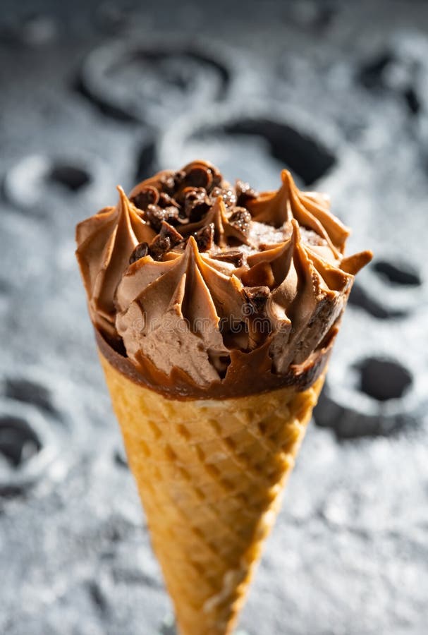A Chocolate Flavor Ice Cream in Front of a Rough Surface with Craters ...