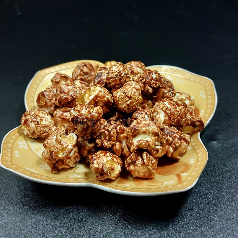 Chocolate-flavored Popcorn in a Modern Golden Plate Stock Image - Image ...