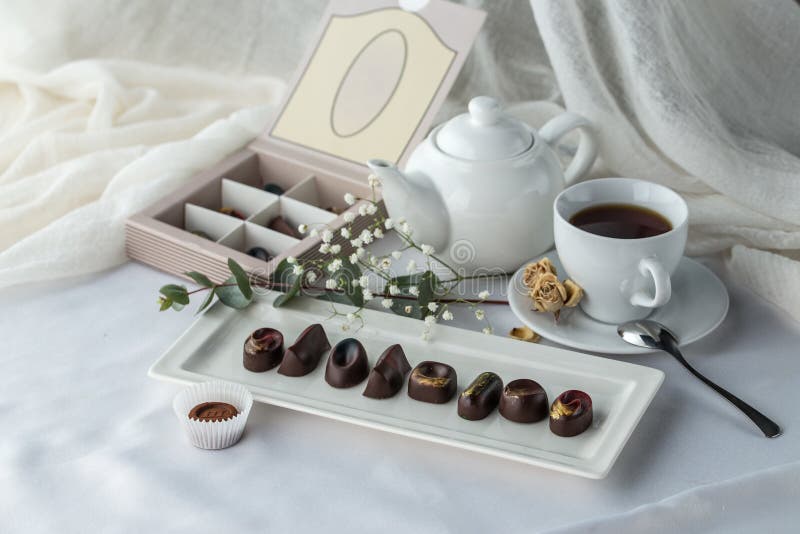 Chocolate Handmade Candies and Cup of Tea on the Table Stock Photo ...