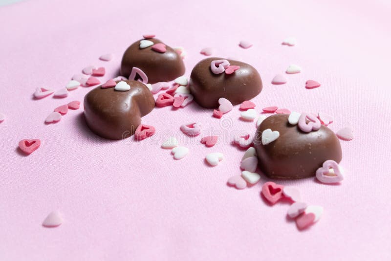 Chocolate Heart Truffles and Pink Heart-shaped Cake Confetti Stock ...