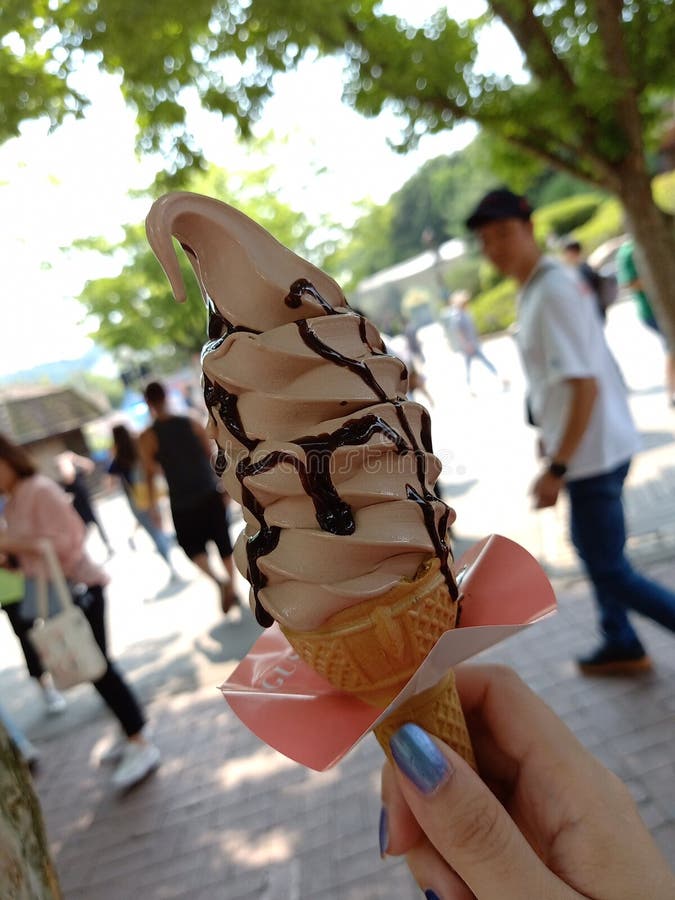 Chocolate Ice Cream Cone in Hand of a Woman Stock Image - Image of ...