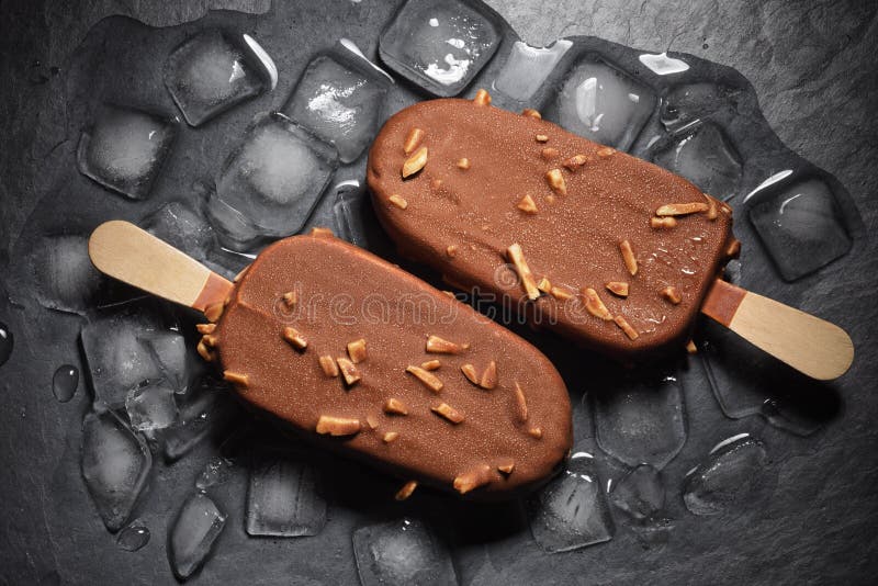 Chocolate Ice Cream Popsicle on Black Background with Ice Stock Photo ...