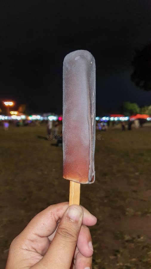 Chocolate Ice Cream Popsicle in Hand To Enjoy Stock Photo - Image of ...