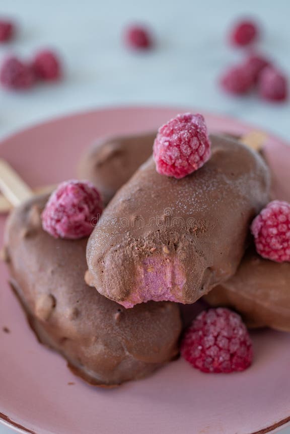 Chocolate Ice Cream on a Stick with Raspberries Stock Photo - Image of ...