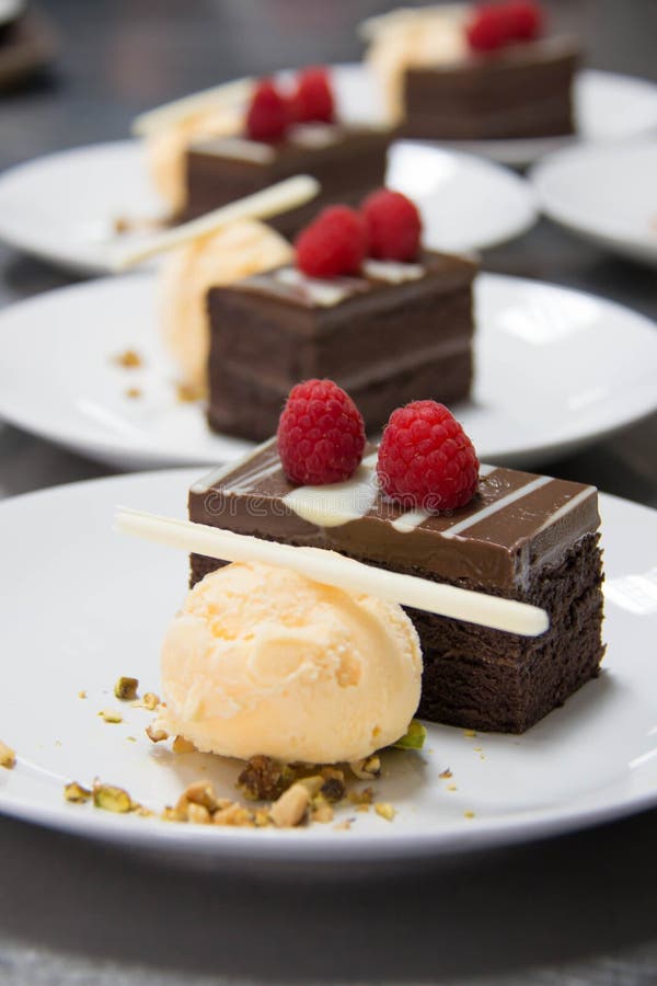 Chocolate Layered Cake Topped with Raspberry and Ice Cream Stock Photo ...