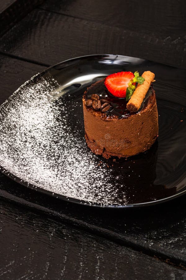 Chocolate Mousse with Strawberry and Chocolate Stick on a Black Dish ...