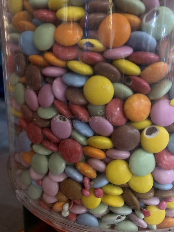 Chocolate Multicoloured Sweets in a Large Plastic Container Stock Photo ...