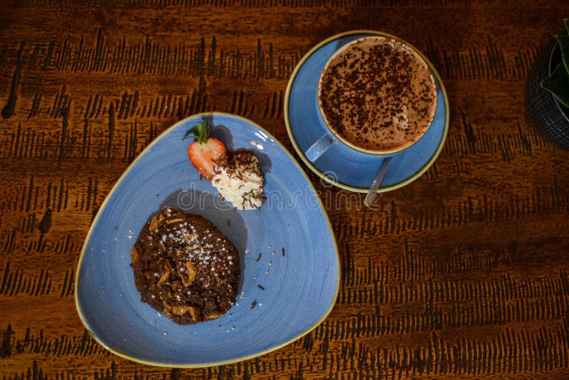 A Chocolate and Nut Cookie with a Hot Chocolate on a Table Stock Photo ...