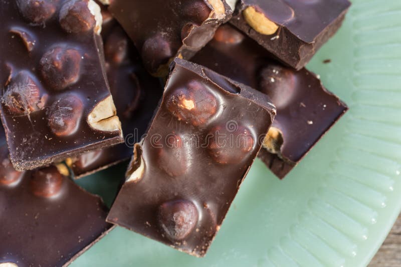 Chocolate and Nuts Chunks on Green Plate Stock Photo - Image of snack ...