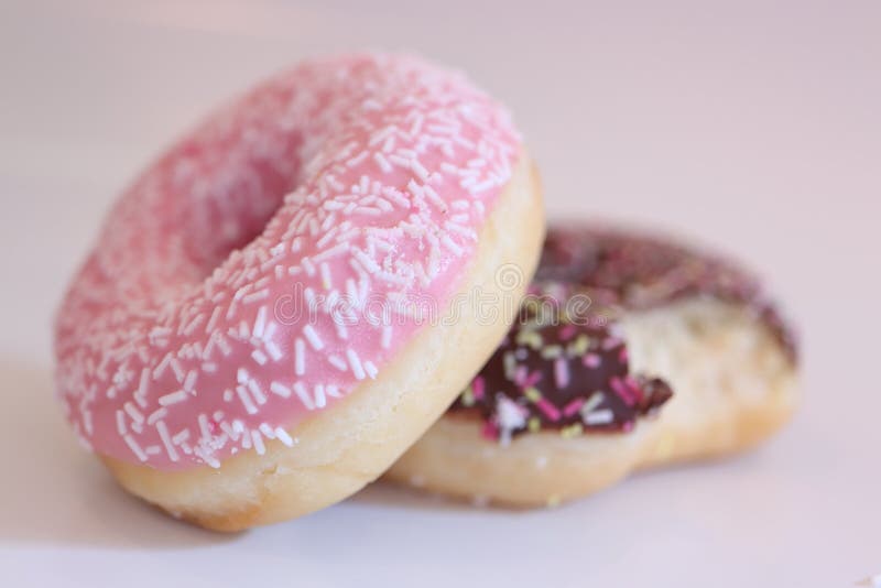 Chocolate and Pink Iced Donuts Stock Photo - Image of food, pink: 143042158