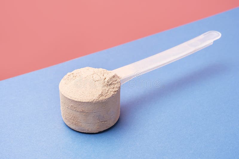 Chocolate Protein Powder in Scoop on Pink and Blue Background. Stock ...