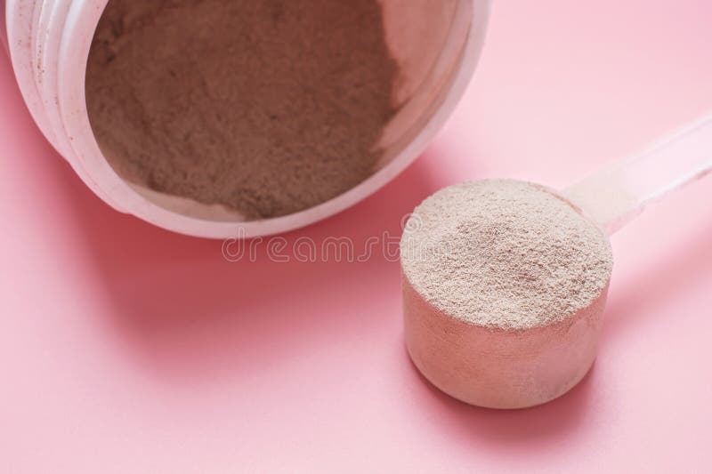 Chocolate Protein Powder in Scoop and Plastic Jar on Pink Background ...