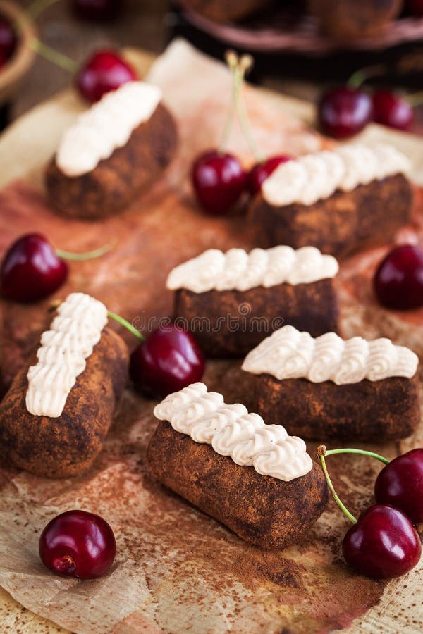 Chocolate Rum Balls Cakes Decorated with Cream and Fresh Cherry Stock ...