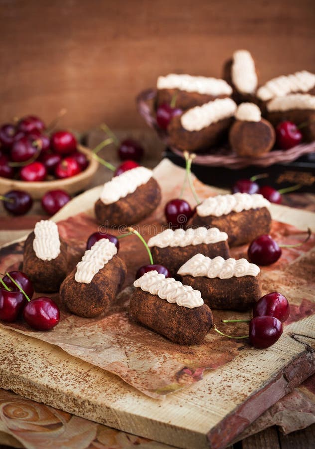Chocolate Rum Balls Cakes Decorated with Cream and Fresh Cherry Stock ...