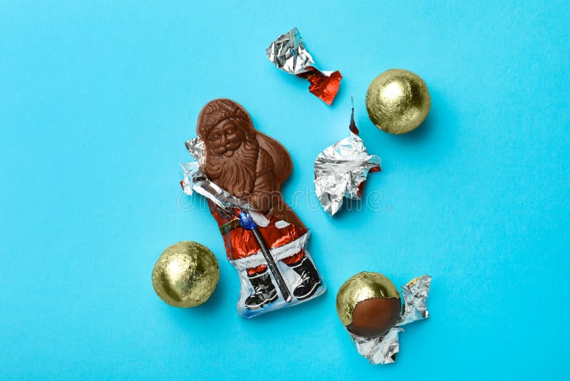 Chocolate Santa Claus and Sweets on Light Blue Background, Flat Lay ...