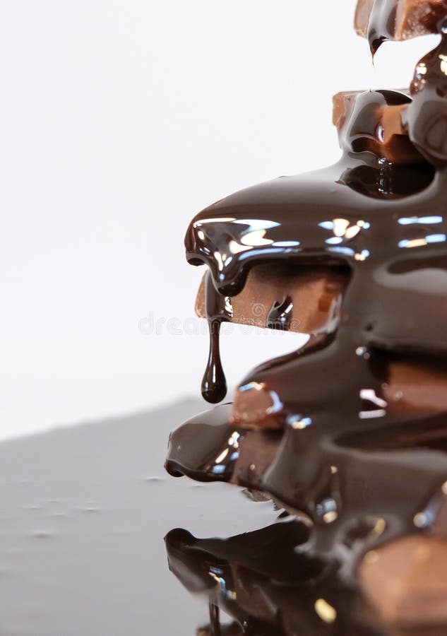 Chocolate Sauce Flowing Over Chocolate Pieces Stock Photo - Image of ...