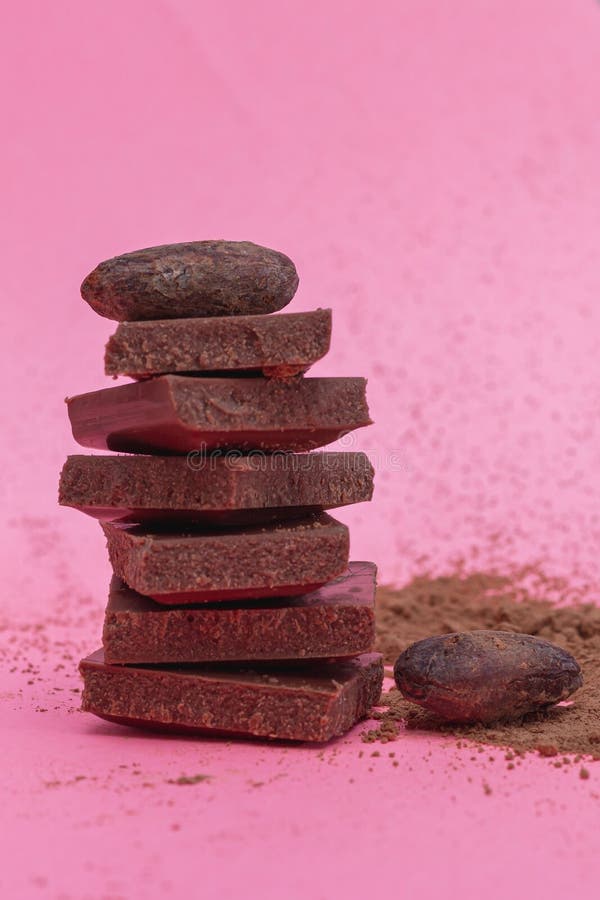 Chocolate Slices, Cocoa Powder, Cocoa Beans on a Pink Background Stock ...