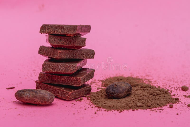 Chocolate Slices, Cocoa Powder, Cocoa Beans on a Pink Background Stock ...