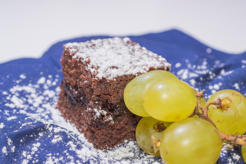 Chocolate Sponge Cake Icing Sugar Grapes Blue Tablecloth Stock Photos ...