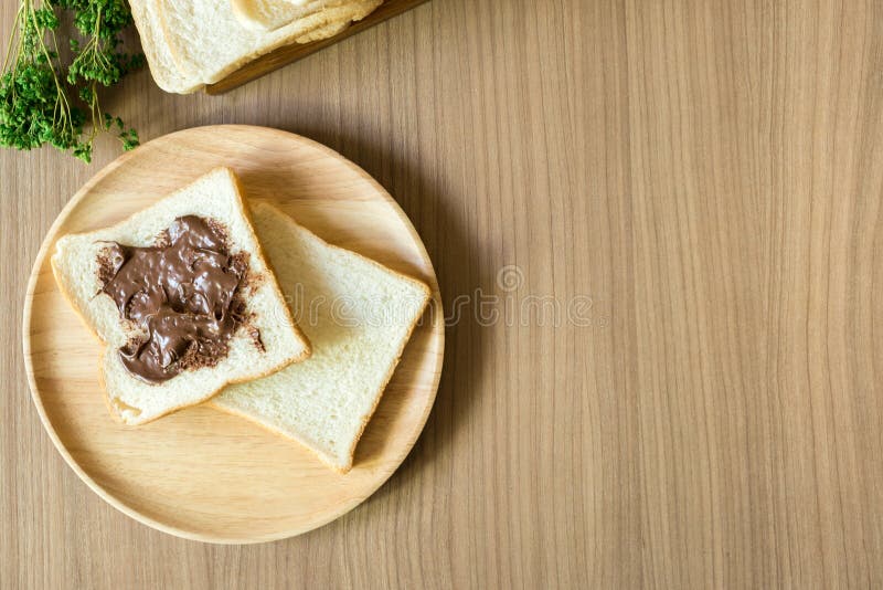 Chocolate Spread on Slice of Bread on the Wood Plate. Stock Image ...
