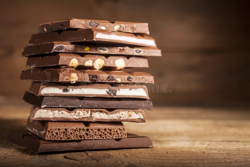 Chocolate Stack on Wooden Background Stock Image - Image of assortment ...