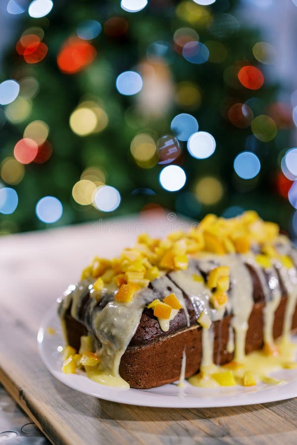 Chocolate Stollen Covered with Icing and Mandarin Pieces Stands on the ...