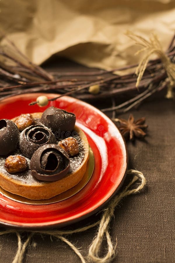 Chocolate Tart on a Red Plate with Decorations Stock Photo - Image of ...