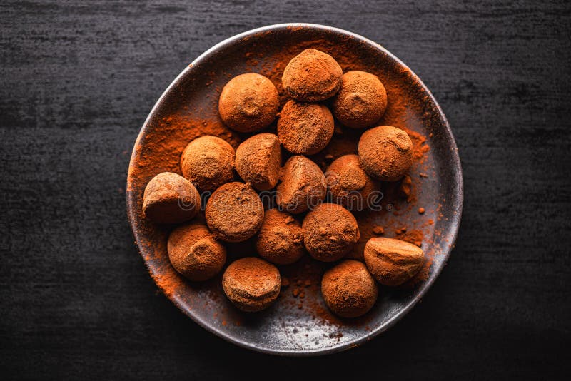 Chocolate Truffles Covered with Cocoa Powder on Plate on Black Table ...