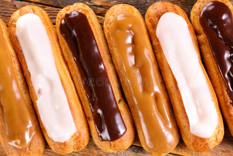 Chocolate, Vanilla and Coffee Eclair Stock Image - Image of wood ...
