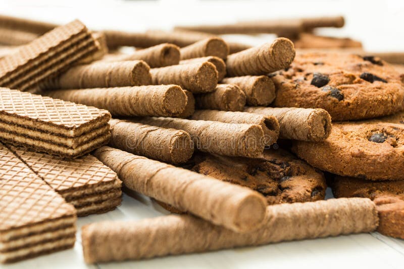 Chocolate Waffle Rolls, Biscuits and Classic Waffle on a Wooden White ...